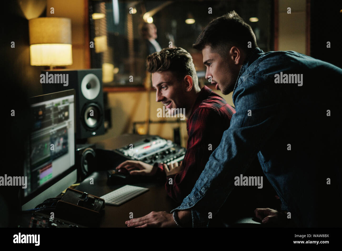 Sound engineer working in a music studio Stock Photo - Alamy