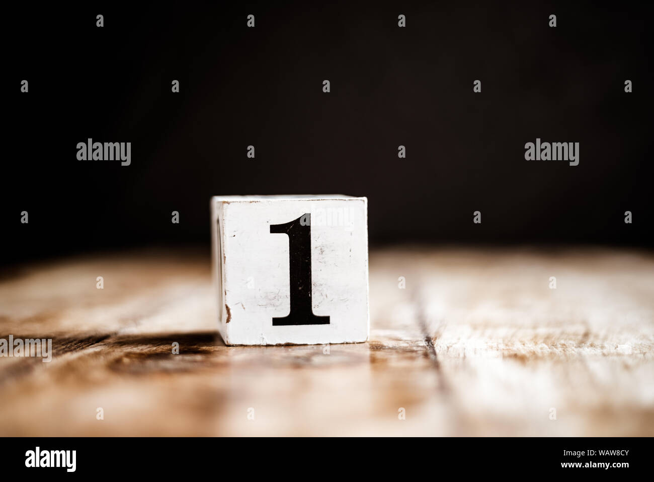 1 - Number 1 - Number One - White block with number on wooden table and ...