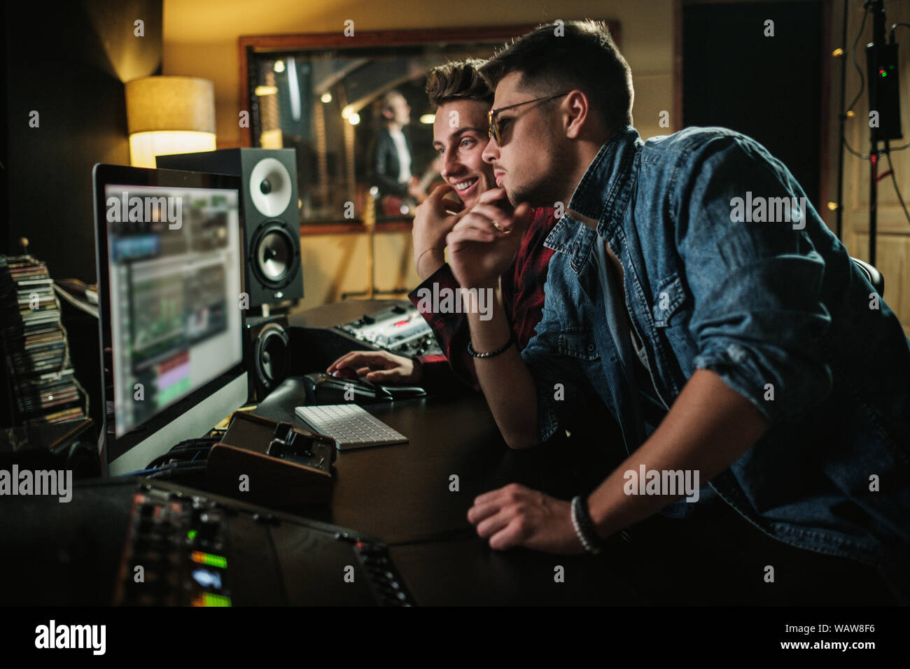 Sound engineer working in a music studio Stock Photo - Alamy