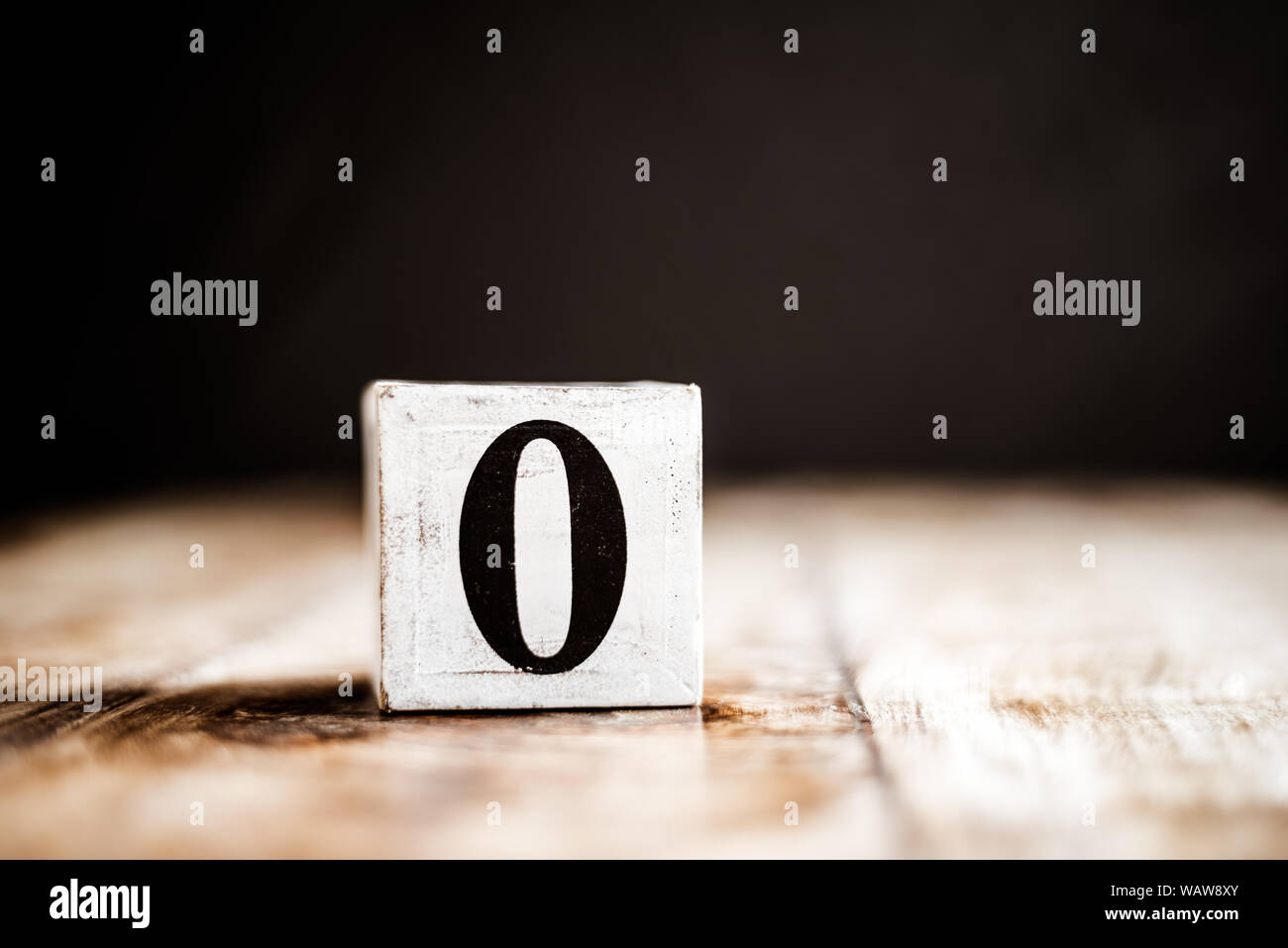 0 - Number 0 - Number Zero - White block with number on wooden table ...