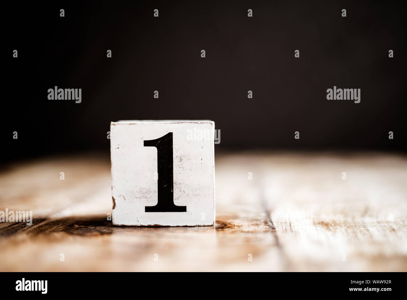 1 - Number 1 - Number One - White block with number on wooden table and ...