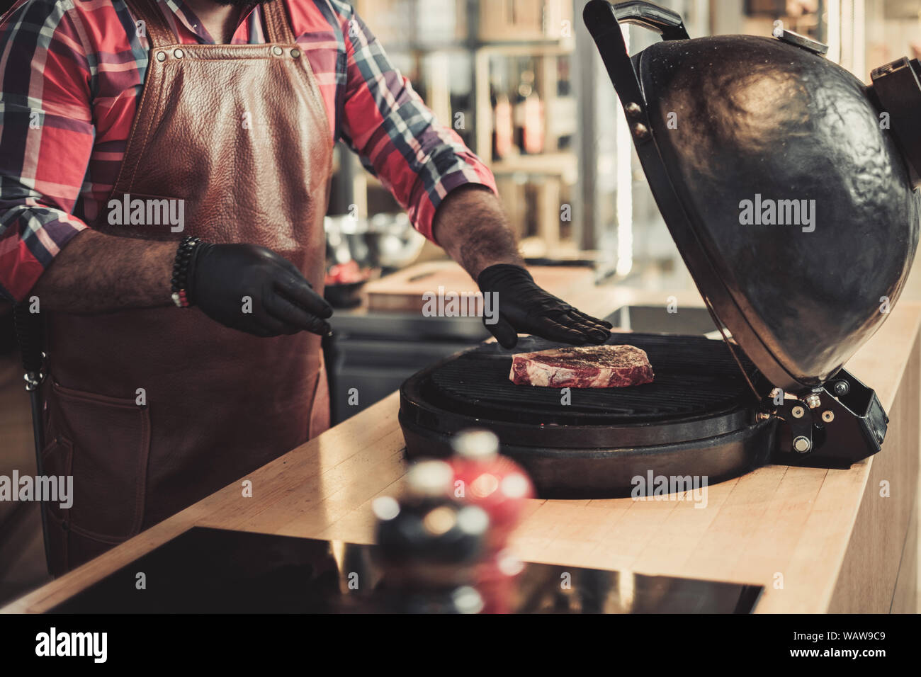 Chef grilling steak in a restaurant Stock Photo - Alamy