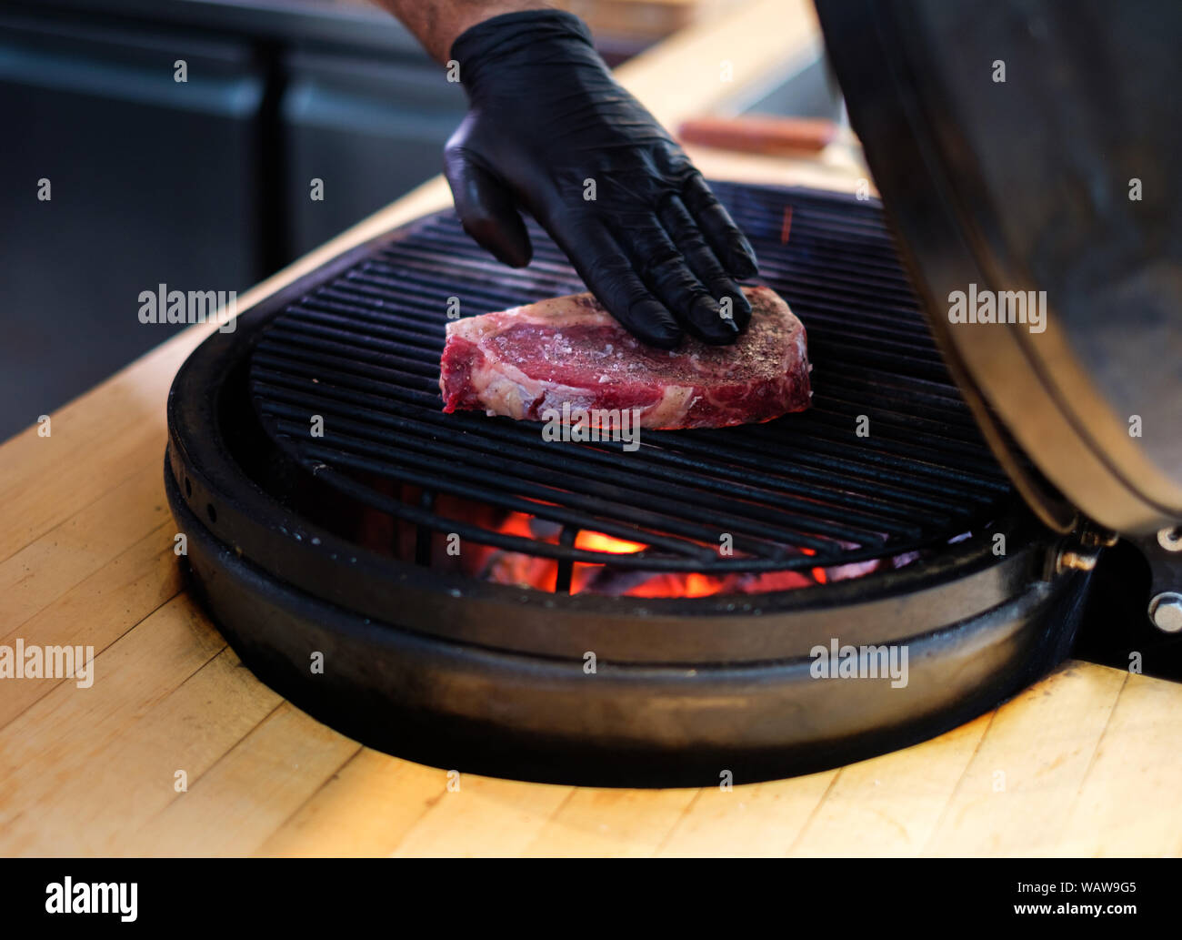Chef grilling steak in a restaurant Stock Photo - Alamy