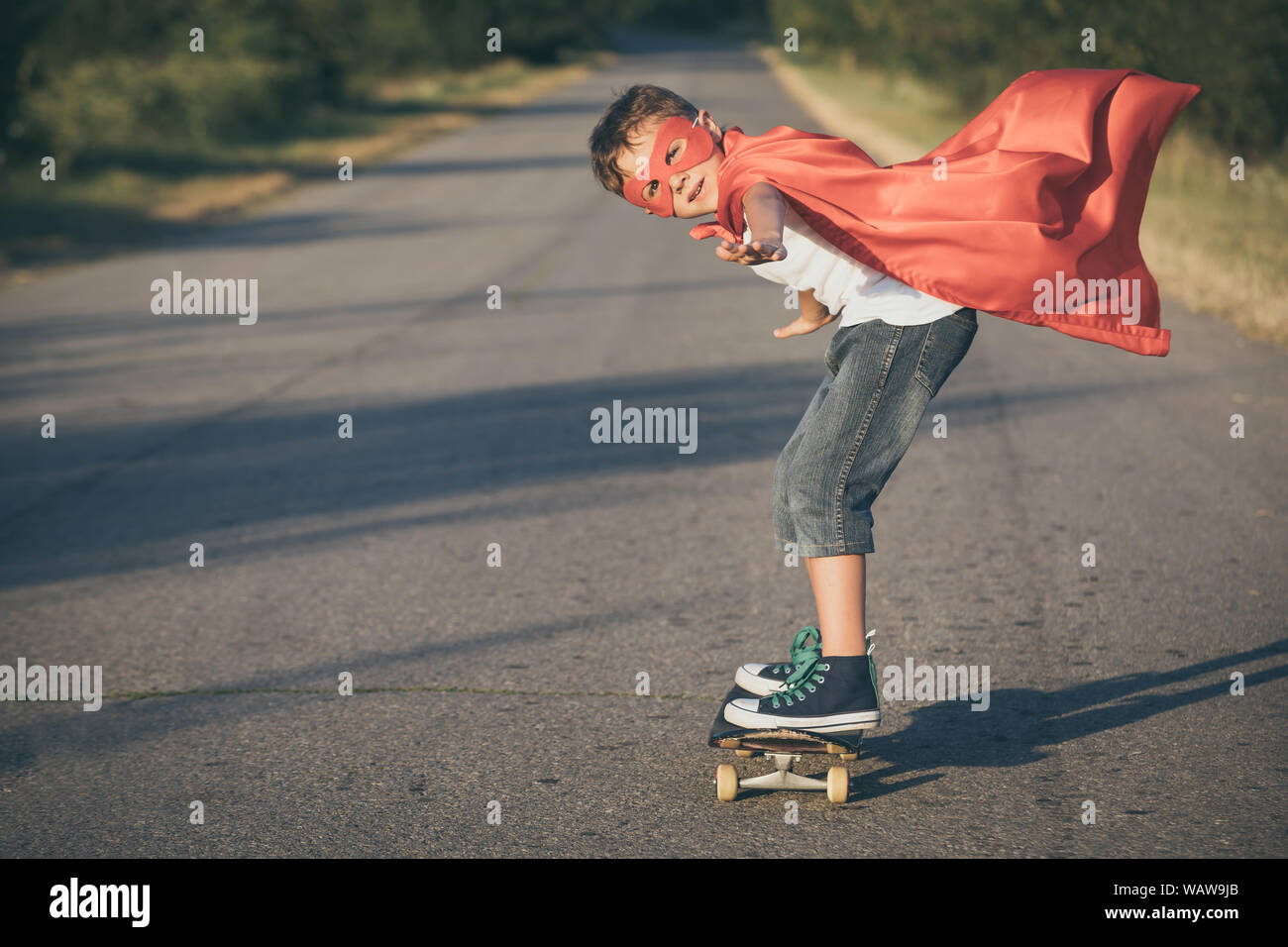 Happy little child playing superhero. Kid having fun outdoors. Concept ...