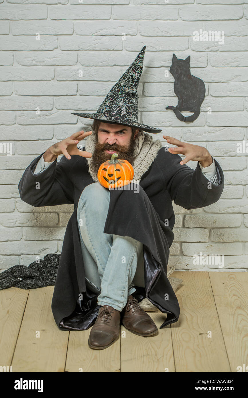 Halloween bad luck. Man in witch hat doing magic on floor. Evil spell ...