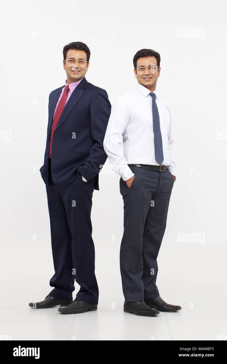 Two business executives standing together back to back Stock Photo - Alamy