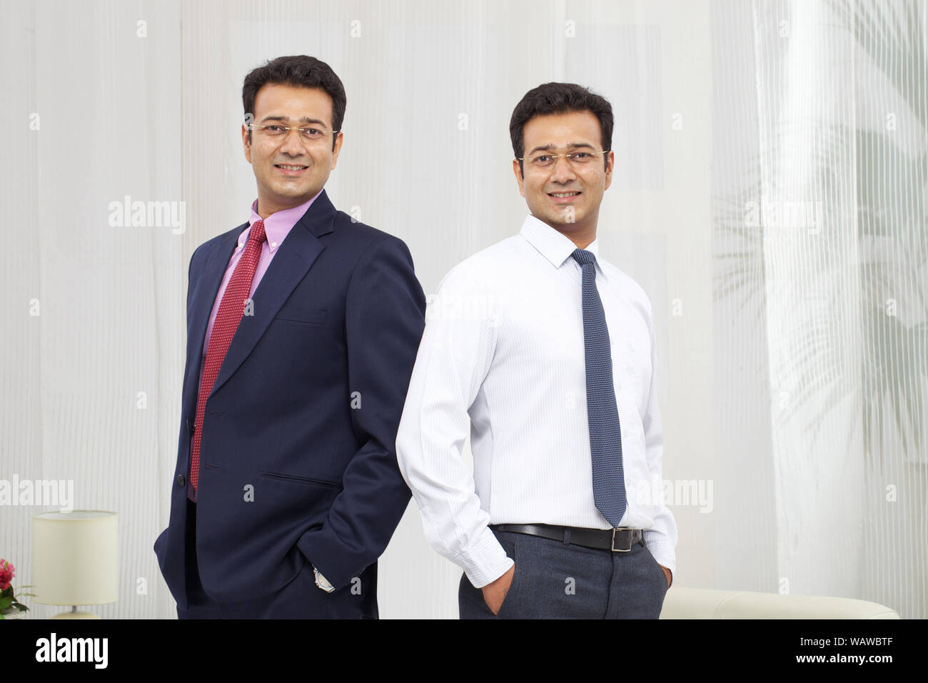 Two business executives standing together back to back Stock Photo - Alamy