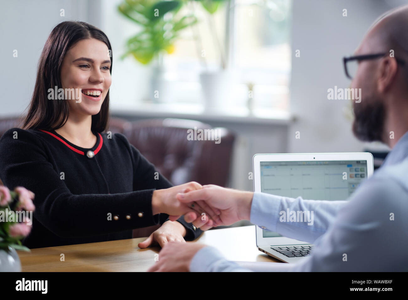 Beautiful brunette woman attending job interview Stock Photo - Alamy