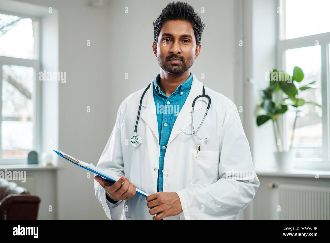 Indian doctor with stethoscope around neck in his office Stock Photo ...
