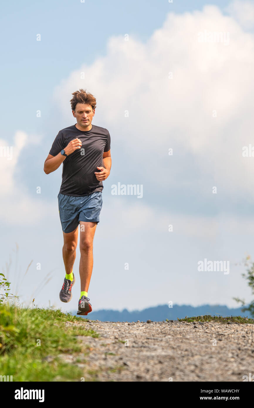 Man runs on road hi-res stock photography and images - Alamy