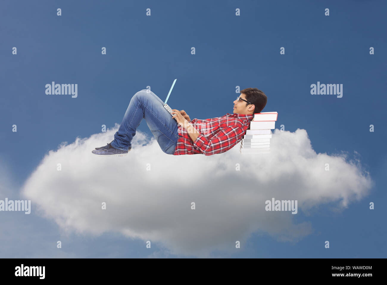 College student lying on clouds and using a laptop concept cloud computing Stock Photo - Alamy
