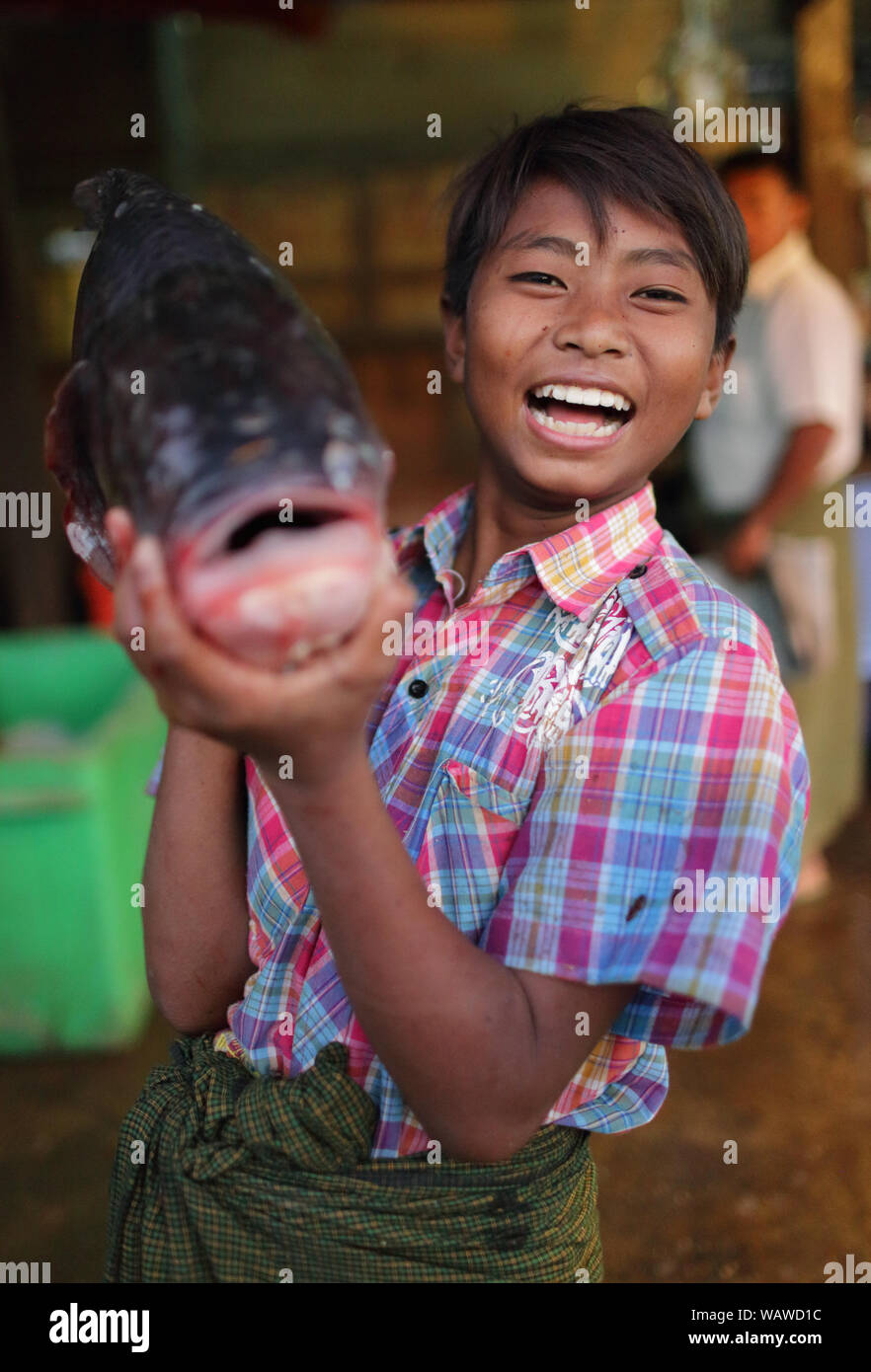 Burmese boy with a fish in Mandalay, Myanmar (Burma Stock Photo - Alamy