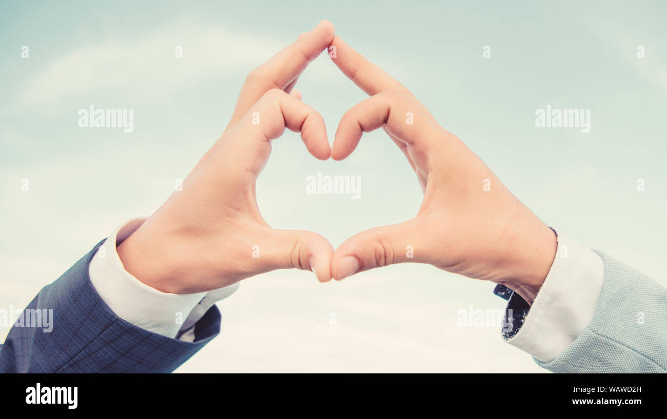 Hand heart gesture forms shape using fingers. Hands put together in ...