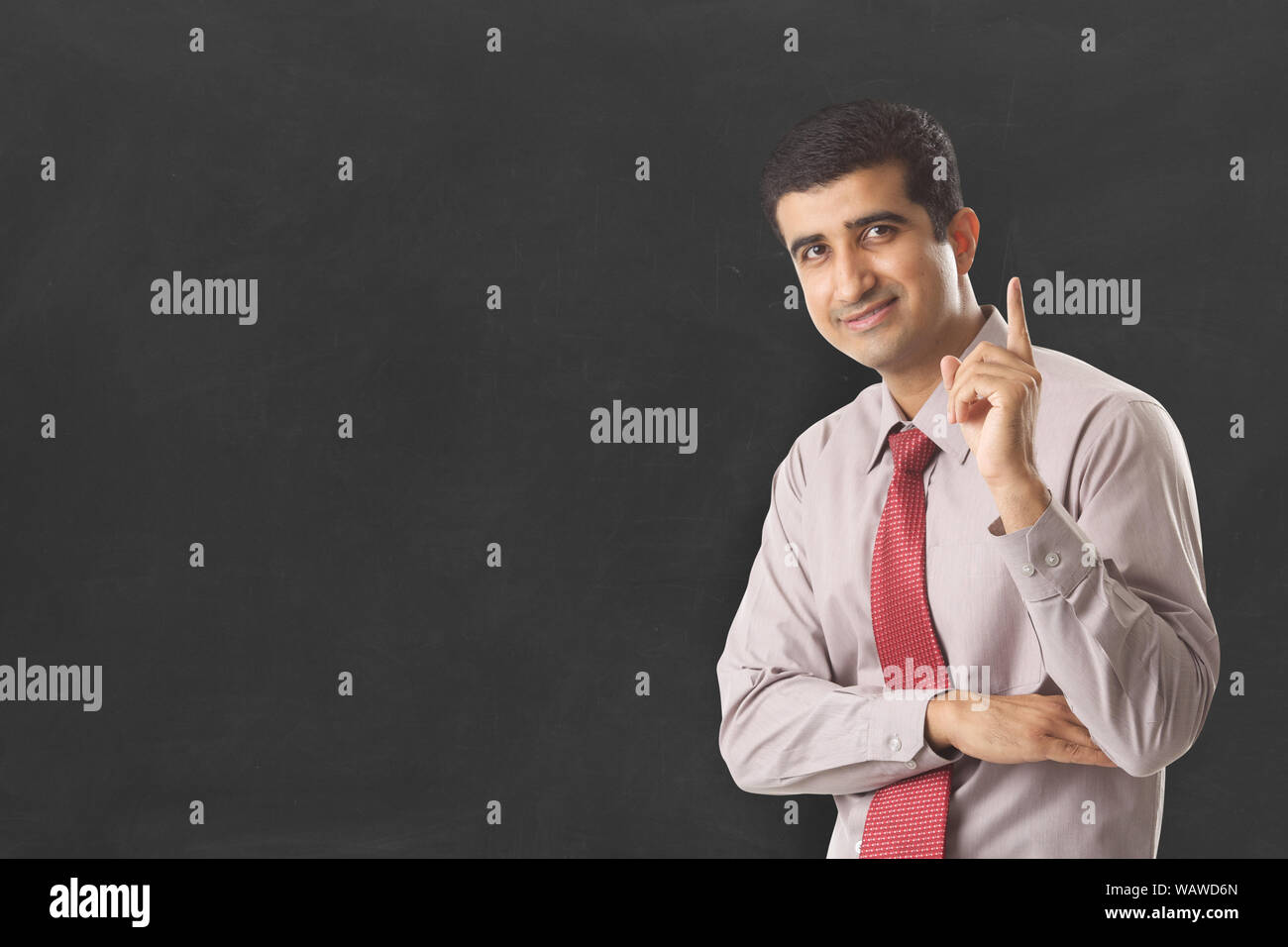 Businessman pointing upward Stock Photo - Alamy