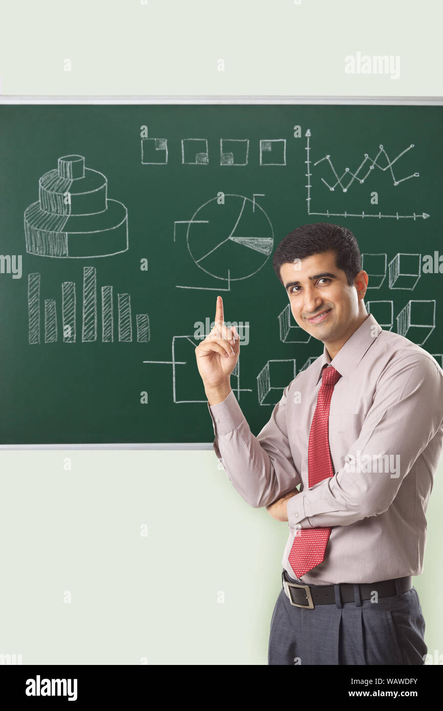 Businessman giving presentation on blackboard and pointing upward Stock ...