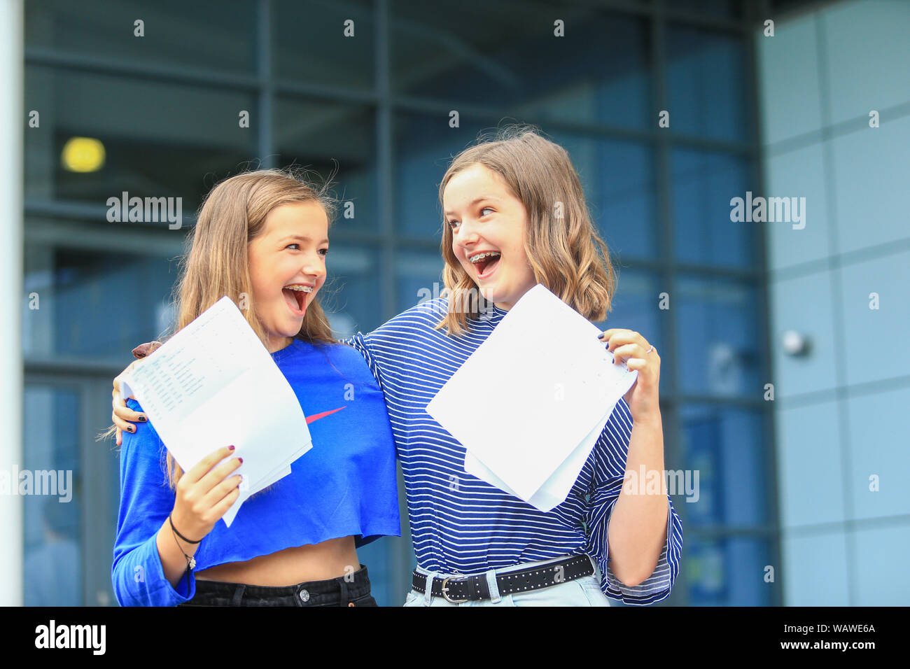 GCSE Exam results day. Twin students open their results letters in a ...