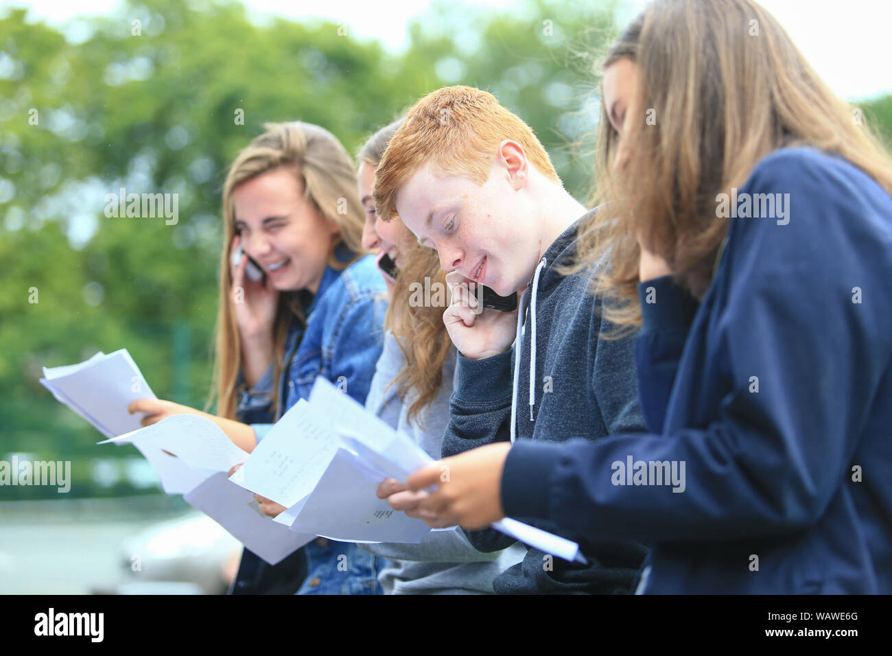 GCSE Exam results day. Students with their exam results letters outside ...