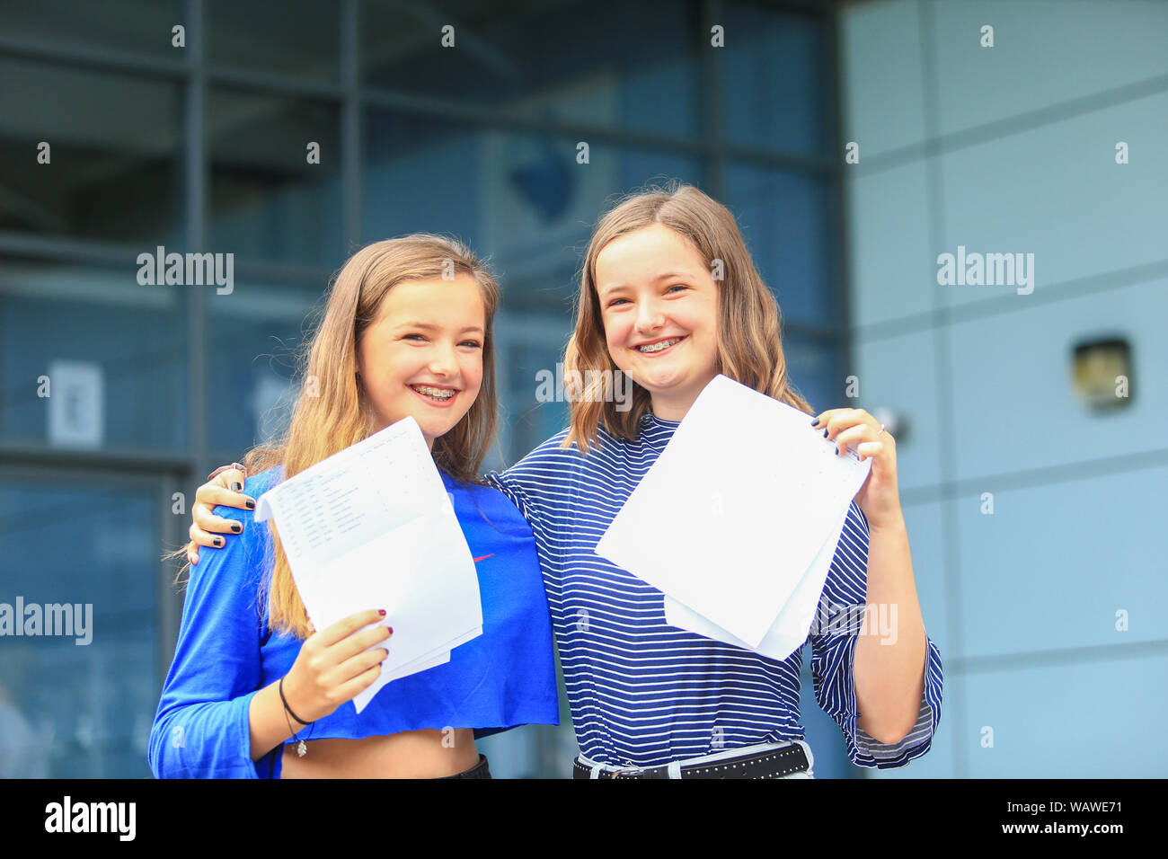 GCSE Exam results day. Twin students open their results letters in a ...