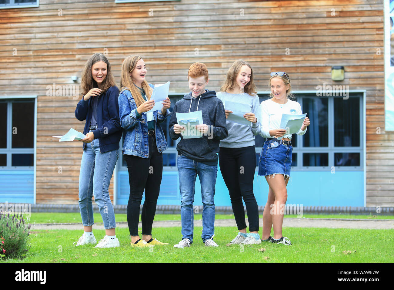 GCSE Exam results day. Students with their exam results letters outside ...