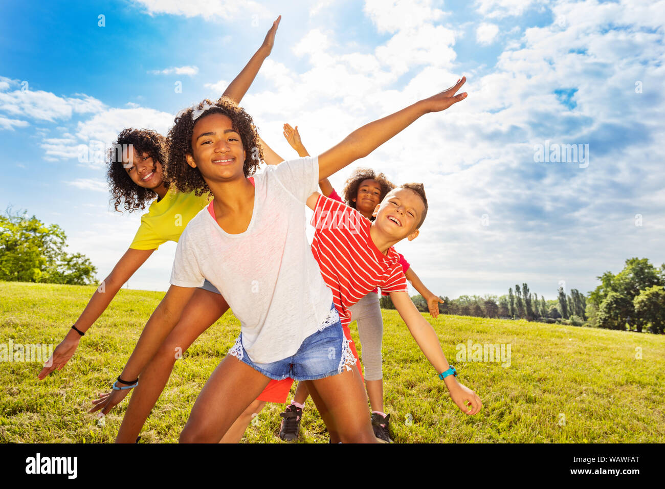 Group of girls and boy smile bending with hands Stock Photo - Alamy