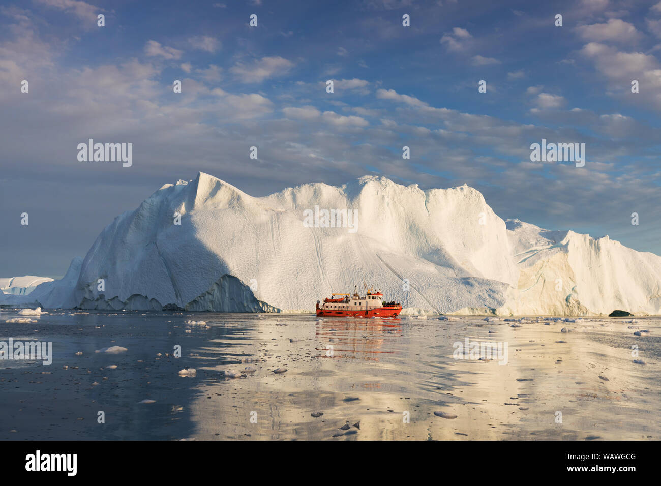 Large iceberg and boat in the Disko Bay, Greenland. The source of these ...