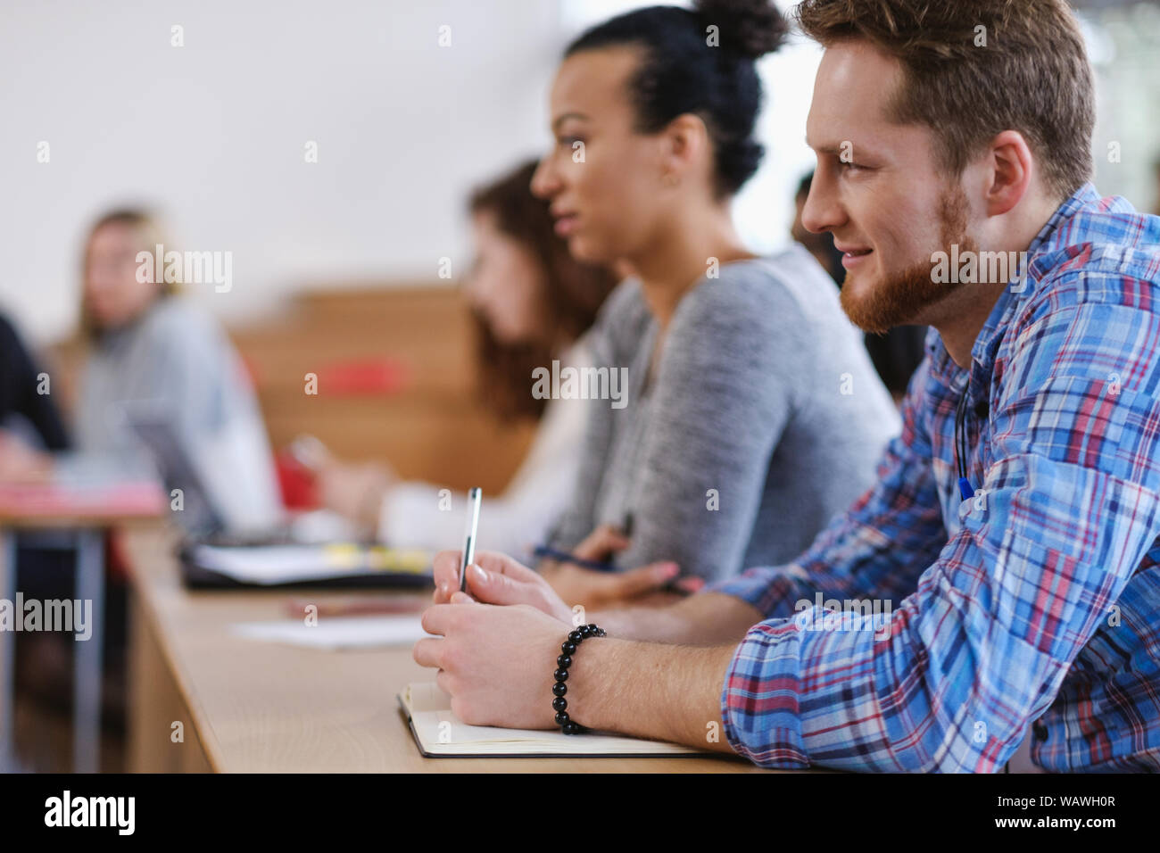 Multicultural group of students in an auditorium Stock Photo - Alamy