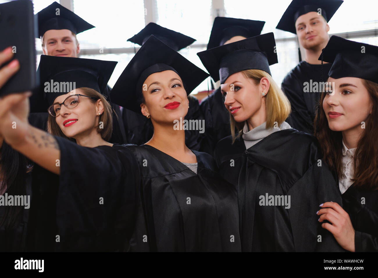Multi ethnic group of graduated students taking selfie Stock Photo - Alamy