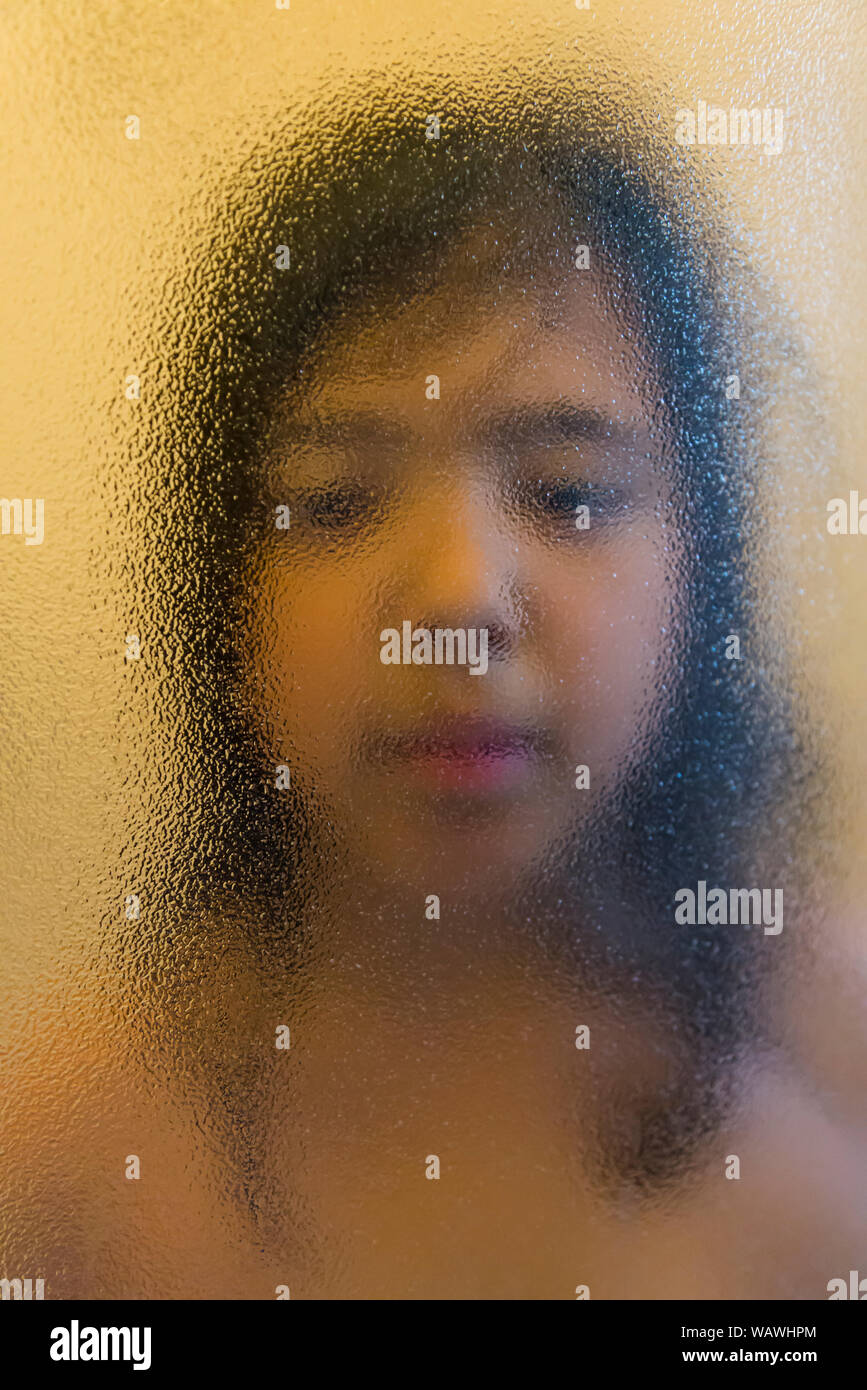 Girl behind frosted glass Stock Photo - Alamy