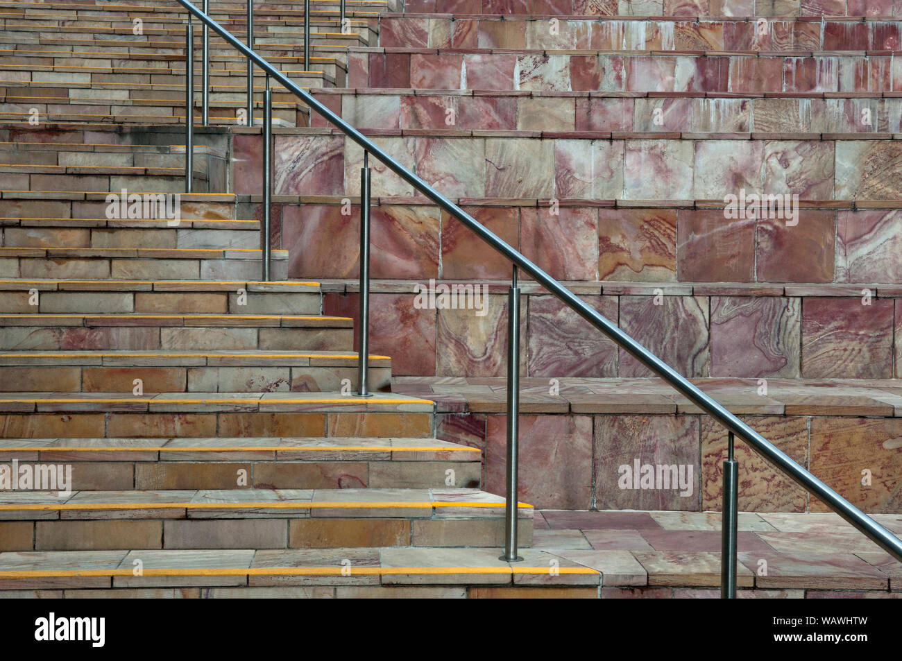 Steps And Seating In Different Coloured Stone Tiling With A Handrail ...
