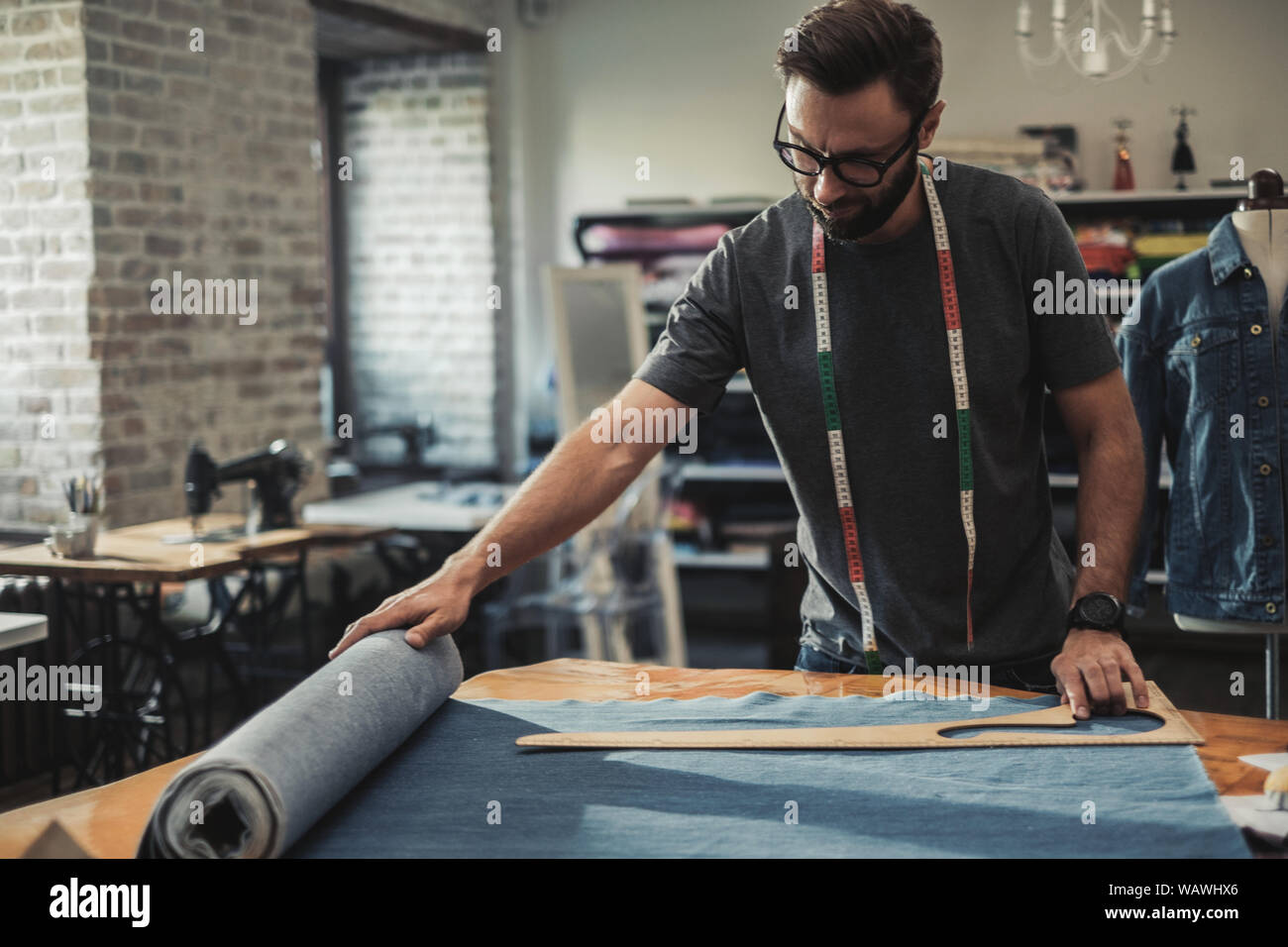 Fashion designer working in his studio Stock Photo - Alamy
