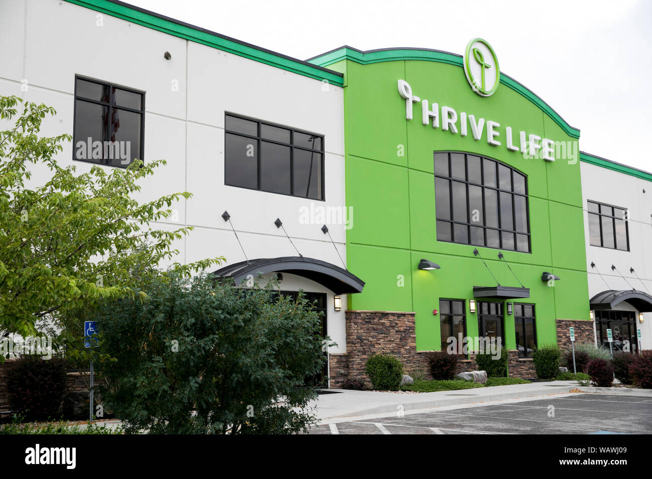 A logo sign outside of the headquarters of Thrive Life in American Fork ...