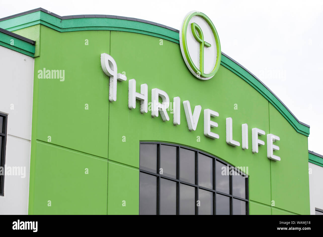 A logo sign outside of the headquarters of Thrive Life in American Fork ...