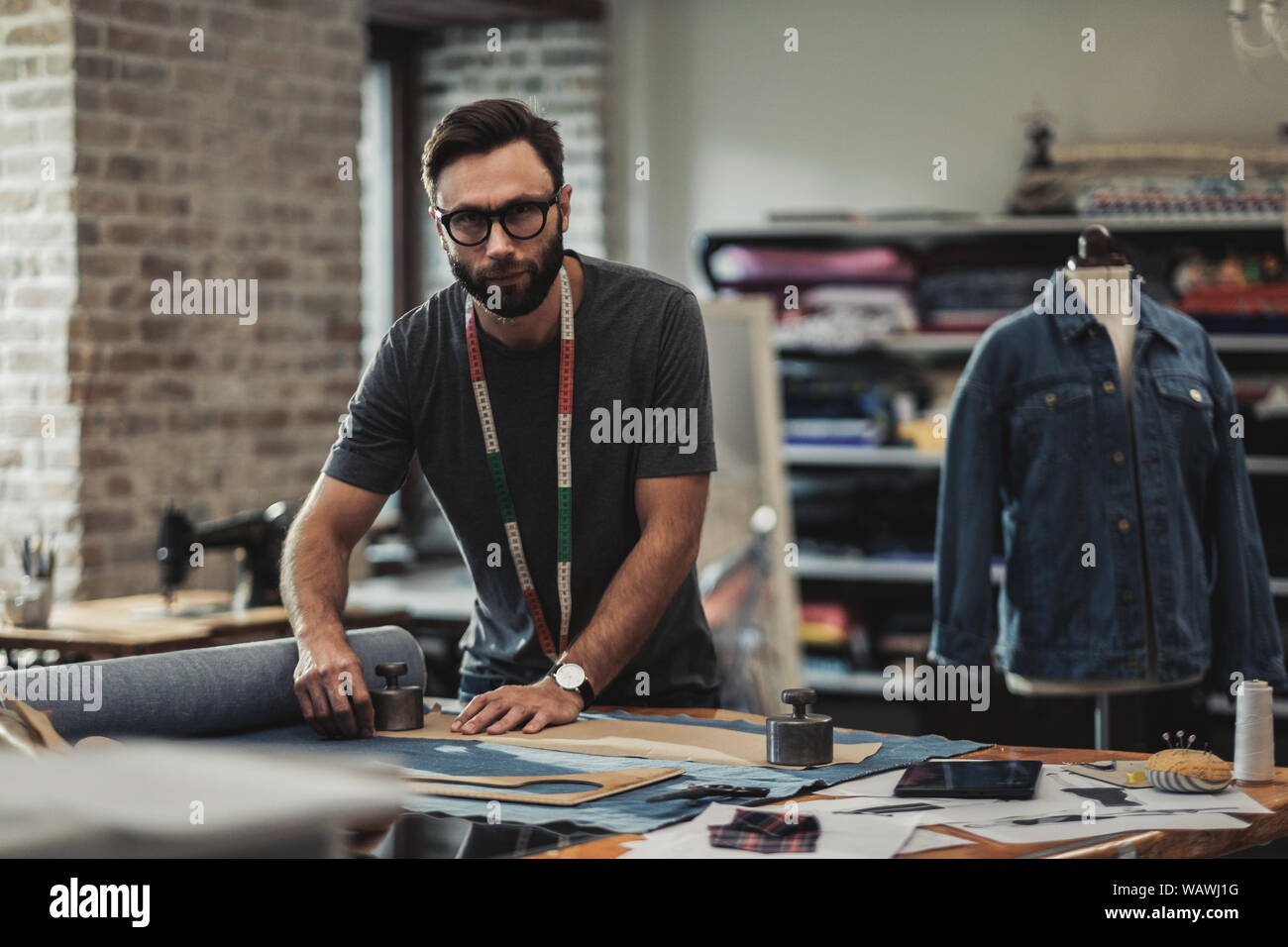 Fashion designer working in his studio Stock Photo - Alamy