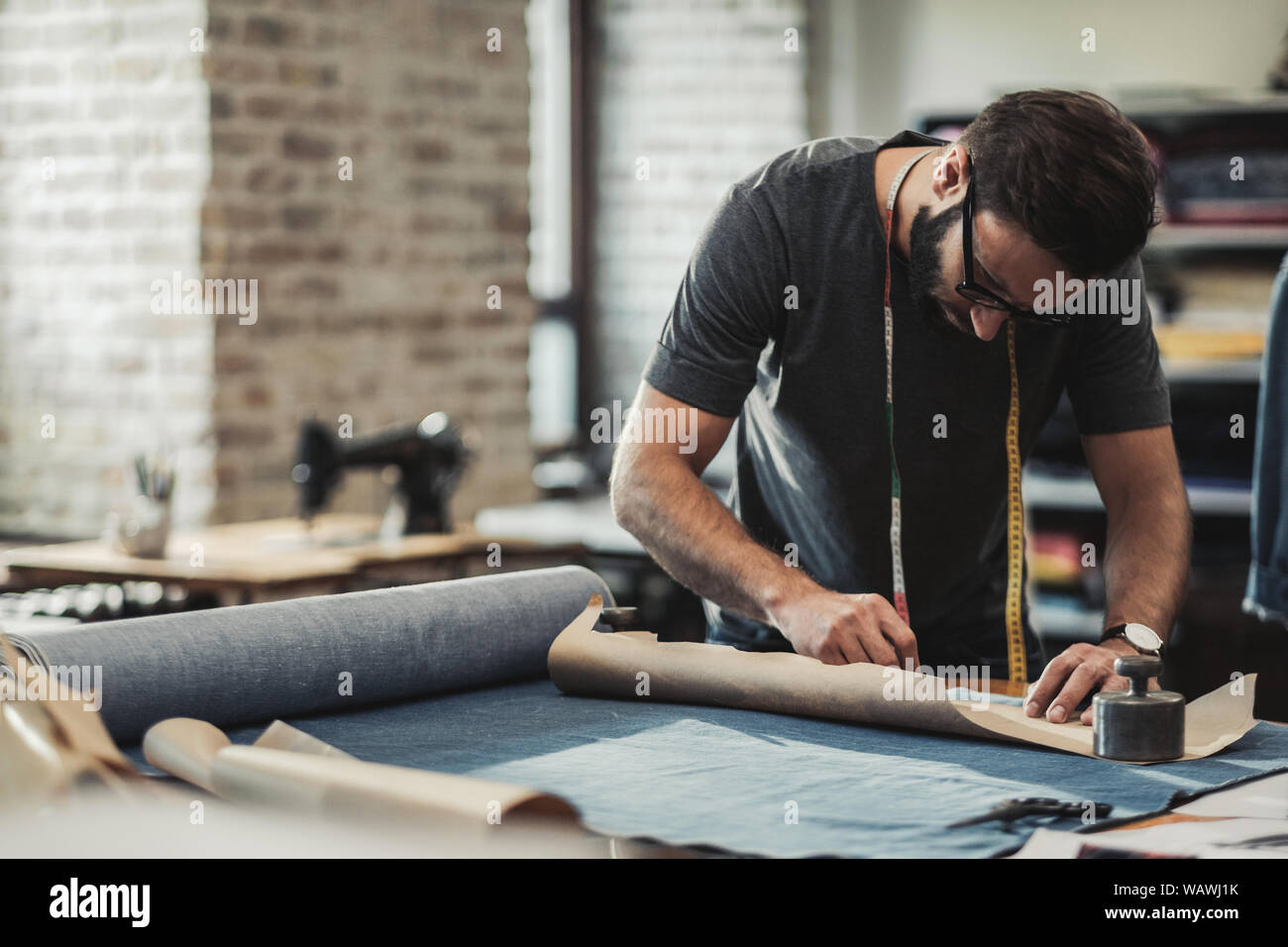 Fashion designer working in his studio Stock Photo - Alamy