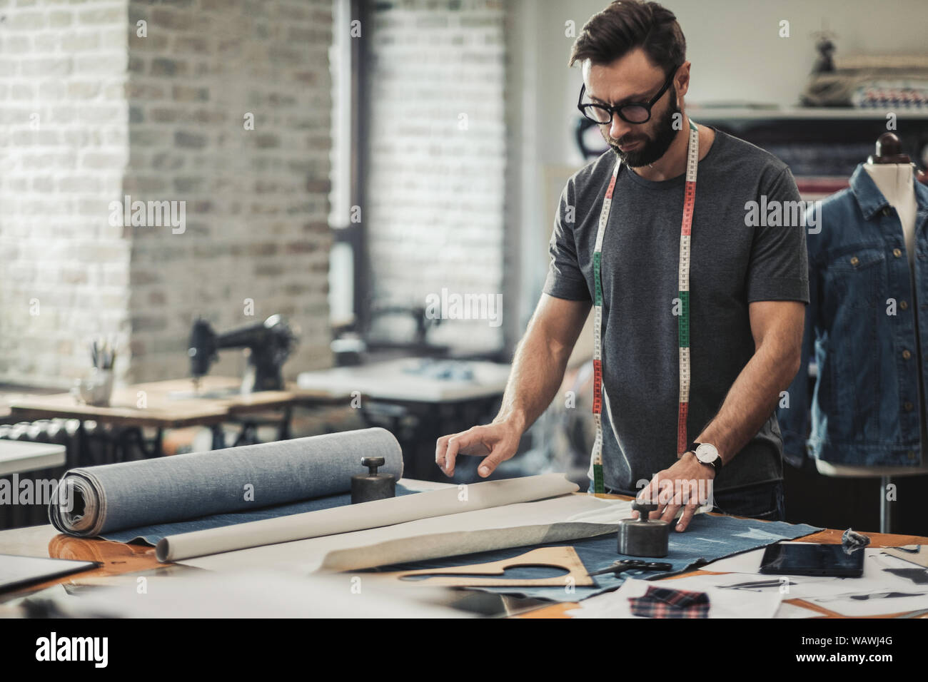 Fashion designer working in his studio Stock Photo - Alamy