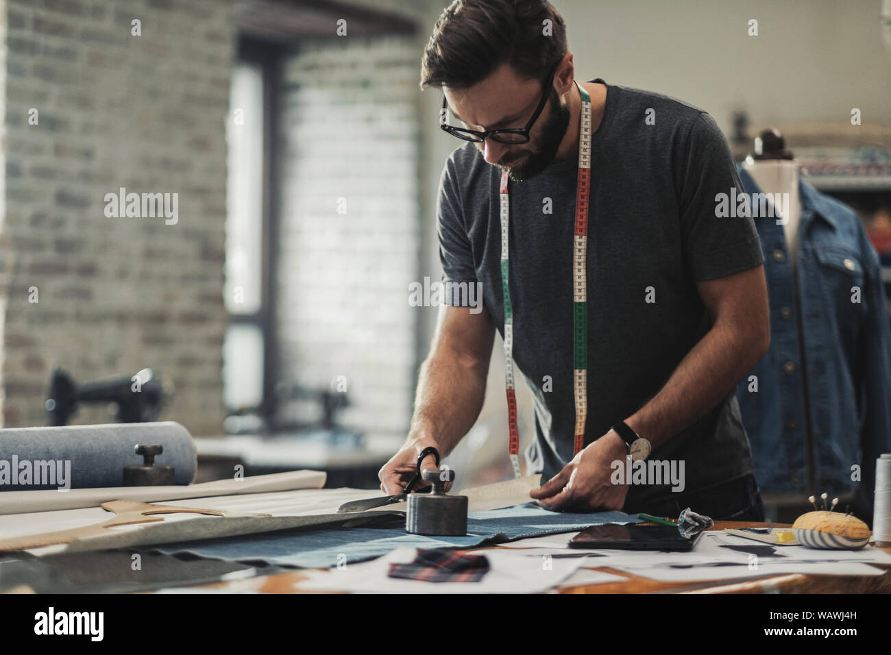 Fashion designer working in his studio Stock Photo - Alamy