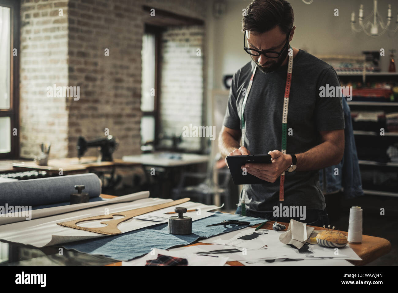 Fashion designer working in his studio Stock Photo - Alamy