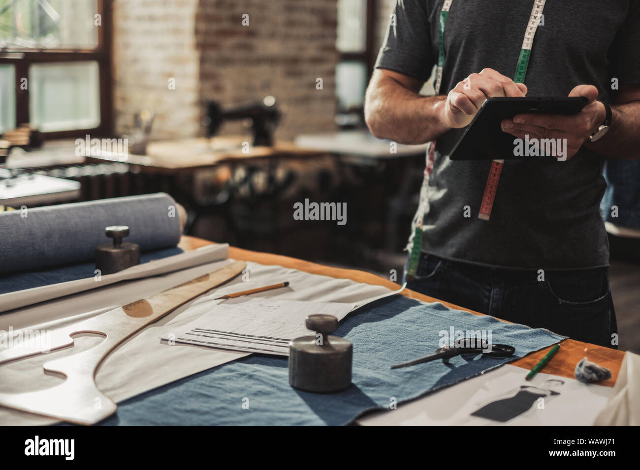 Fashion designer working in his studio Stock Photo - Alamy