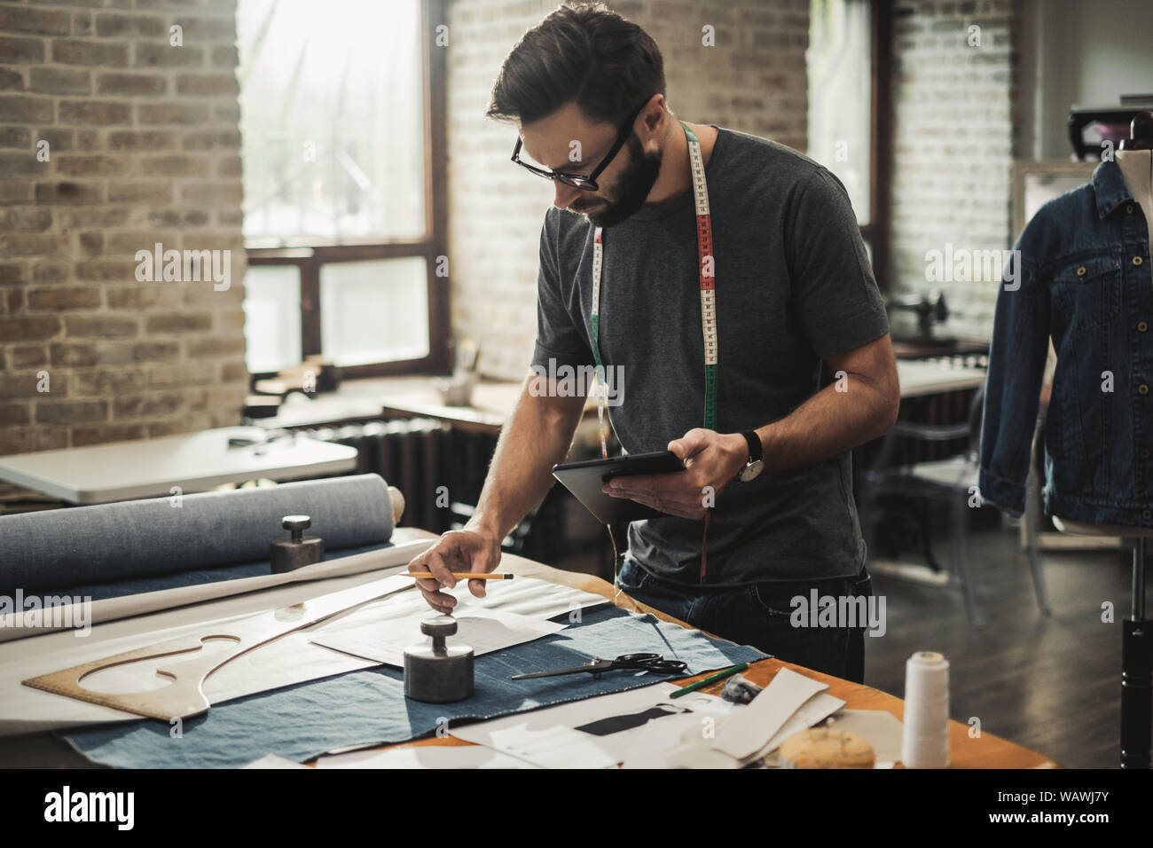 Fashion designer working in his studio Stock Photo - Alamy