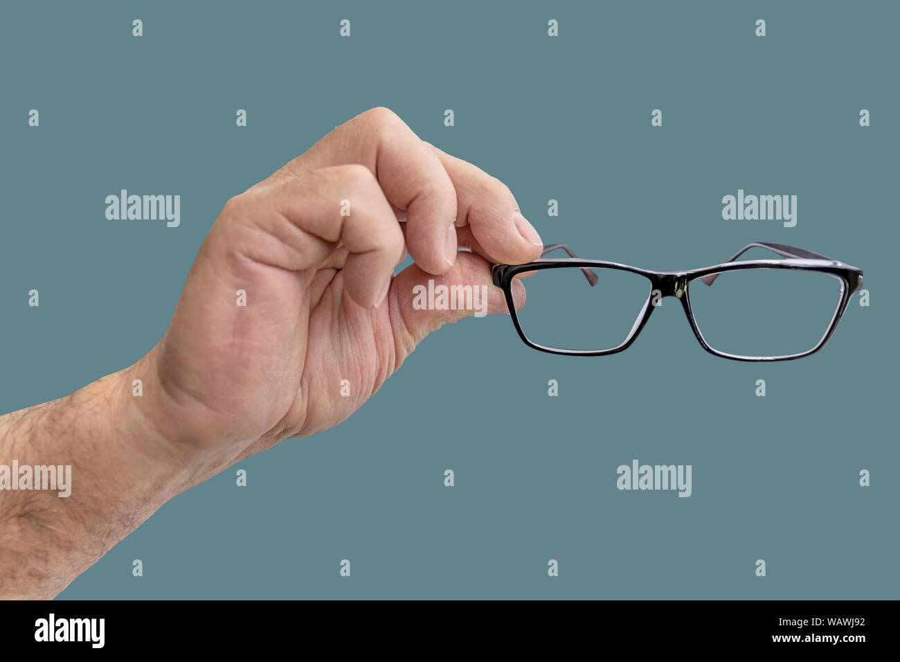 Hand holding Eye Glasses Isolated on green pastel background Stock ...