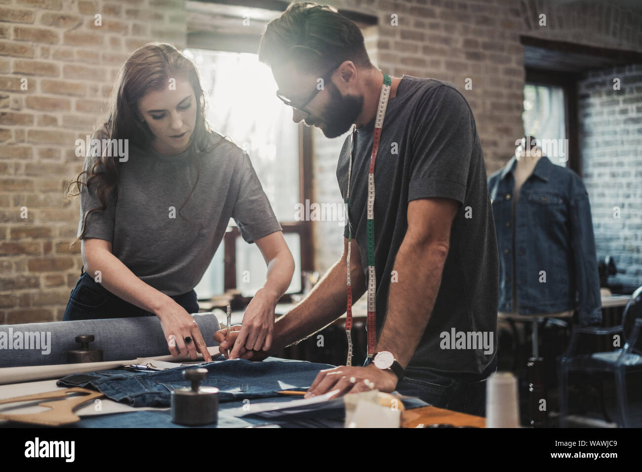 Fashion designer working in his studio Stock Photo - Alamy