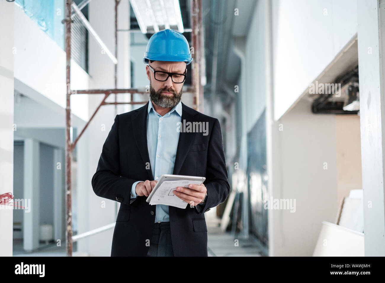 Man engineer with a blueprints Stock Photo - Alamy