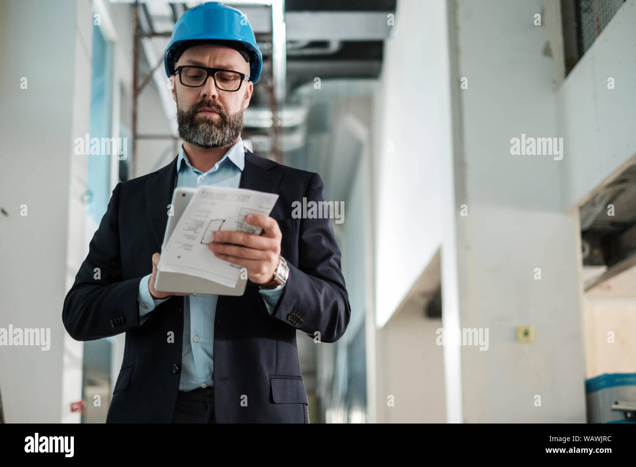 Man engineer with a blueprints Stock Photo - Alamy