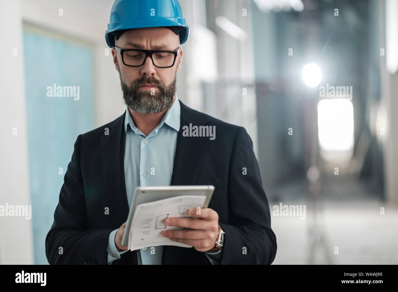 Man engineer with a blueprints Stock Photo - Alamy
