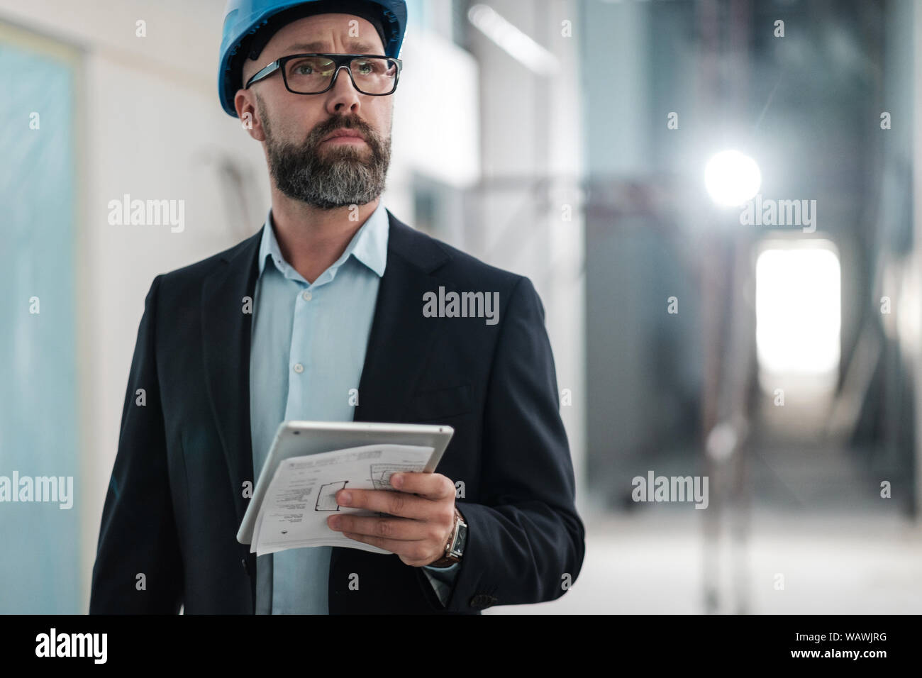 Man engineer with a blueprints Stock Photo - Alamy