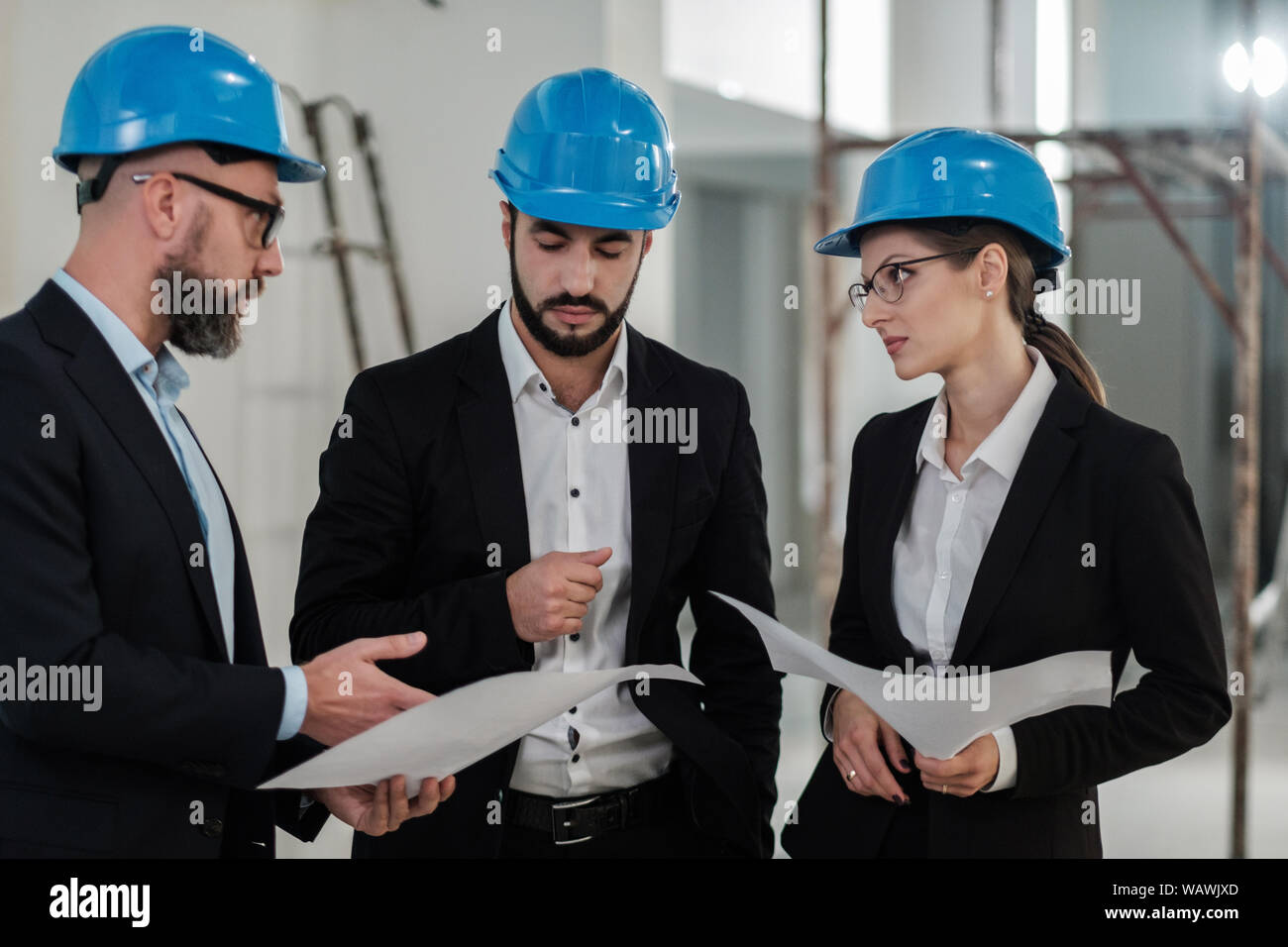 Engineers in hardhats have conversation Stock Photo - Alamy