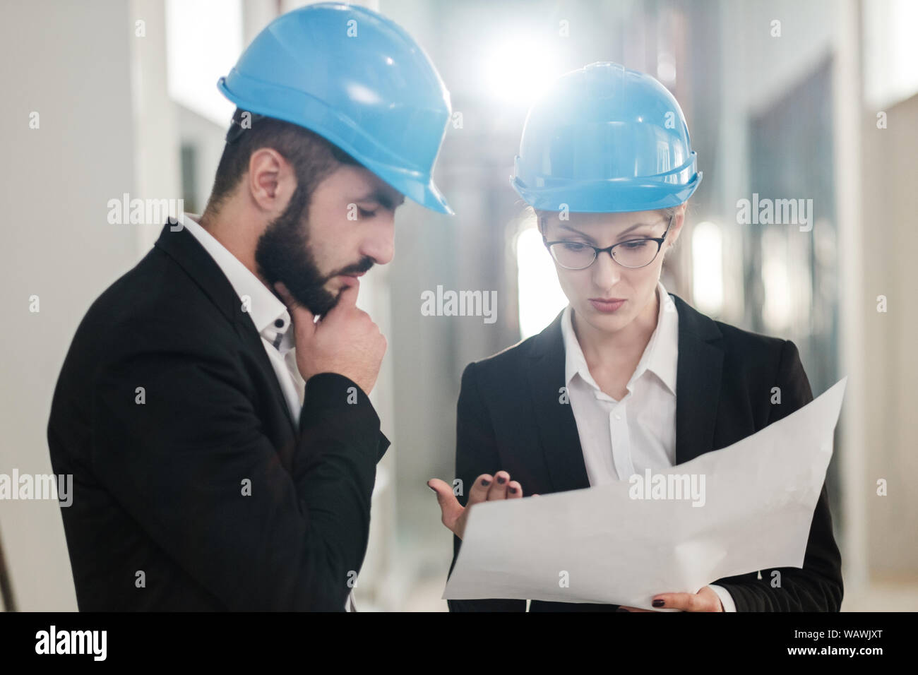 Engineers in hardhats have conversation Stock Photo - Alamy