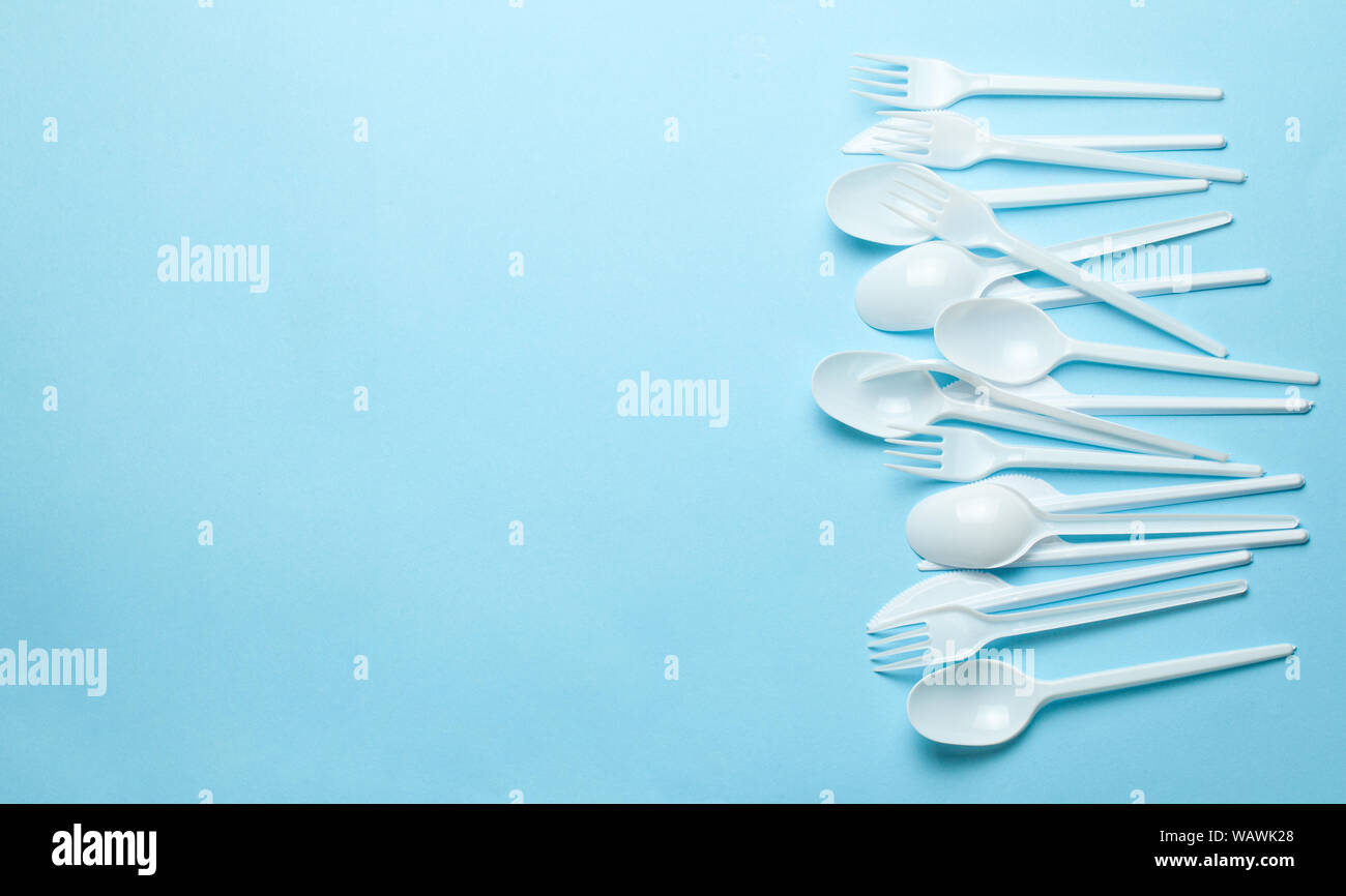 Plastic cutlery, forks, spoons and knives. Pollution of the environment ...