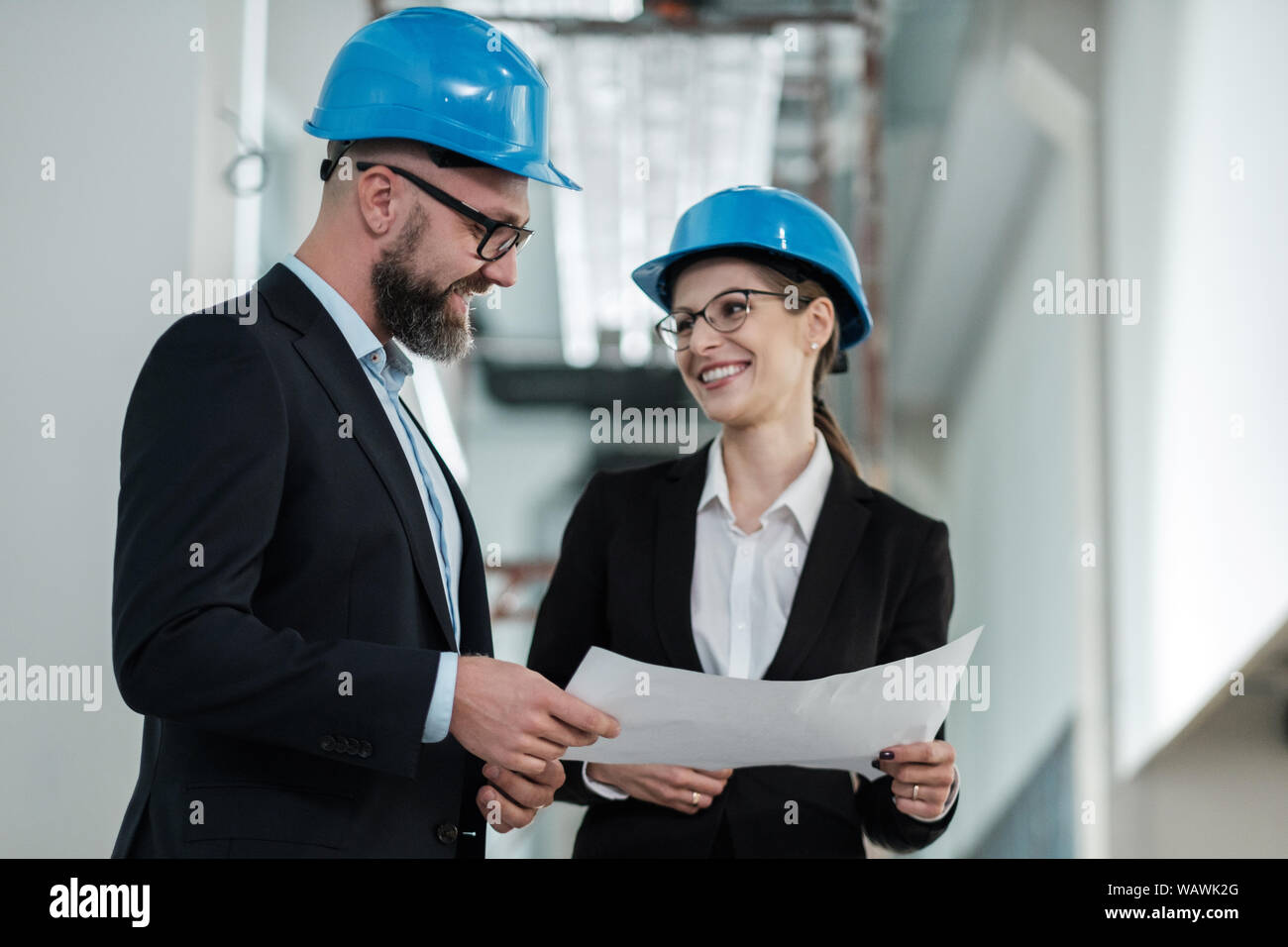 Engineers in hardhats have conversation Stock Photo - Alamy