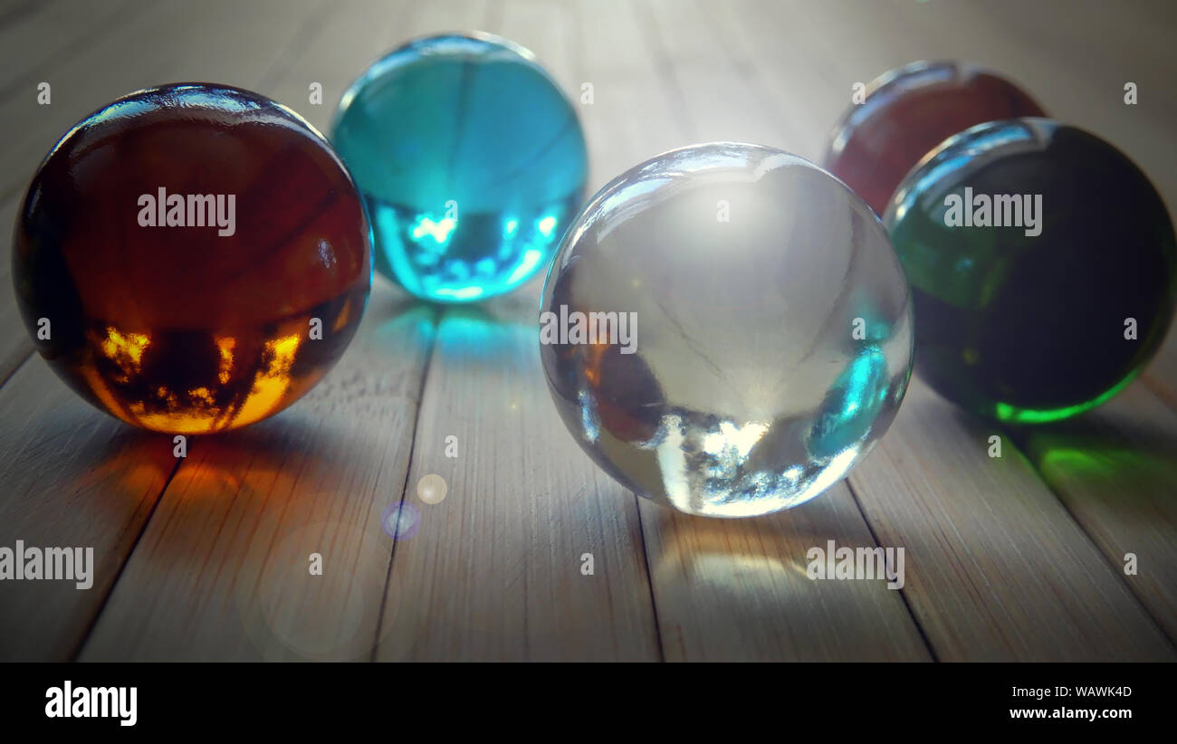 Still life photography of five colorful glass balls in the sunny beams ...